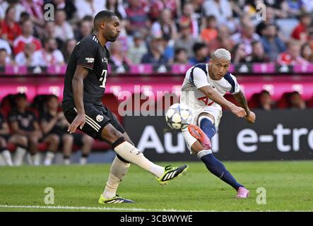 Richarlison of Tottenham Hotspur on the ball pressured by Michael ...