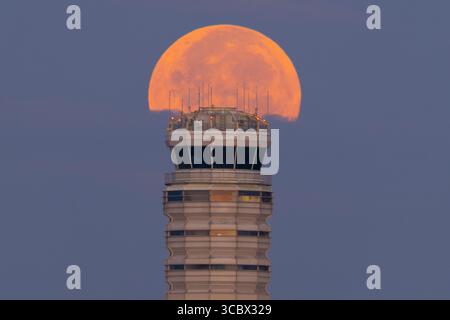 The full moon known as the Sturgeon Moon sets over DCA National Airport ...