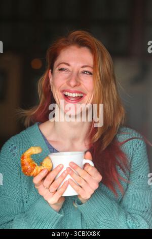 Young ginger happy woman laughing and showing thumb up isolated over ...