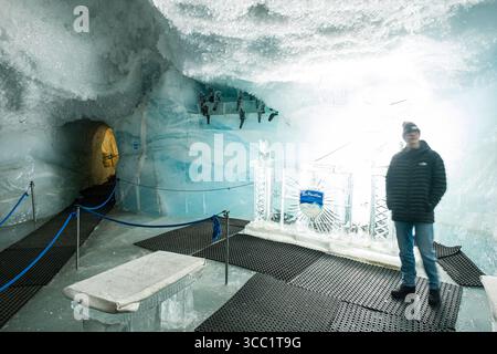 Tourist viewing exhibits in the Mittelallalin Ice Pavilion, Saas-Fee ...