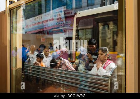 Hindu devotees praying through a glass window, Shreemant Dagdusheth ...