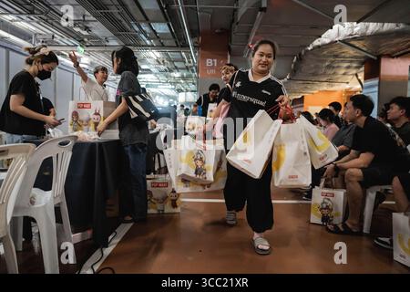 Shoppers collect POP MART bags at a pickup point set up in the parking ...