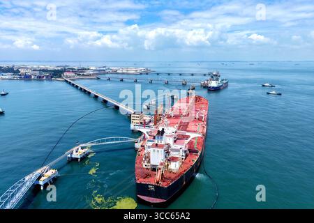 An oil tanker unloads imported crude oil at Qingdao Port in east China ...