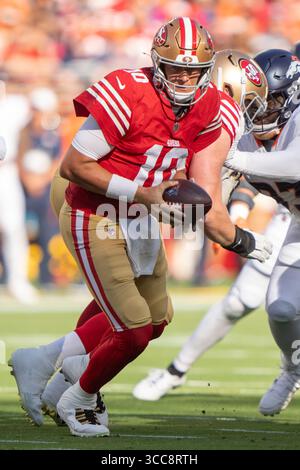 San Francisco 49ers quarterback Mac Jones (10) tosses a lateral pass ...