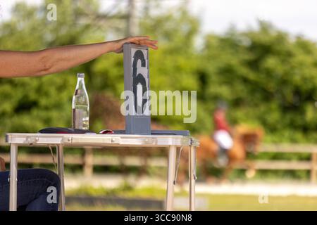 Equestrian competition judge showing score card – horse riding event ...