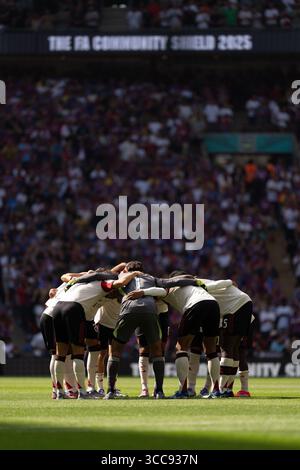 Liverpool's players in a huddle before the Premier League match between ...