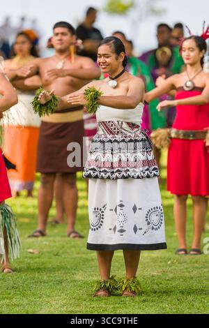 Smiling female wearing Poyaisian attire practicing a dance before the ...