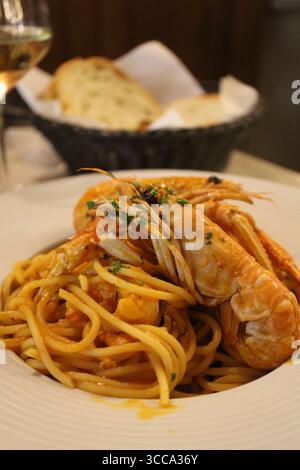 Italian cuisine: spaghetti alla busara (spaghetti with scampi and ...