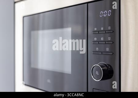 Chrome built in oven and microwave on cupboards in kitchen Stock Photo ...