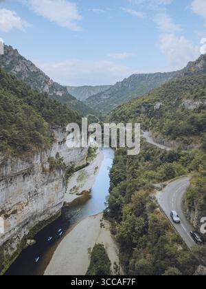 Aerial view of the Tarn River carving through towering limestone cliffs ...