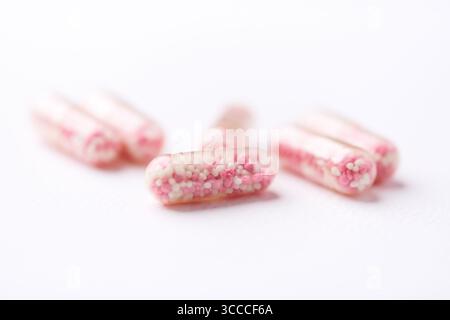 Vitamin B12 (also known as cobalamin) capsules on bright paper ...