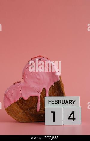 Heart shaped strawberry berry croissant on pink background with copy ...