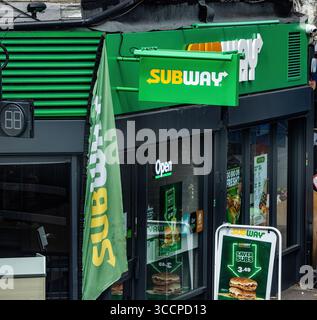 Subway restaurant storefront with illuminated open sign and logo on ...