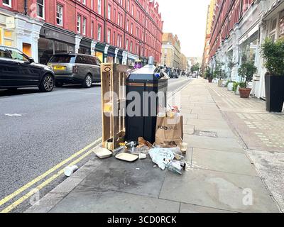 Overflowing garbage bin in Chiltern Street, London Marylebone, London ...