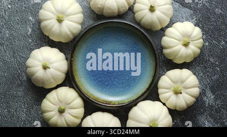 Small white Baby boo mini pumpkins placed in circle with blue ceramic ...