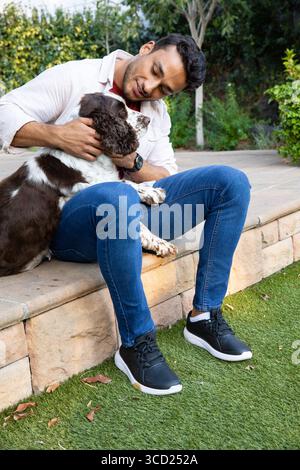 Man holding his spaniel dog Stock Photo - Alamy