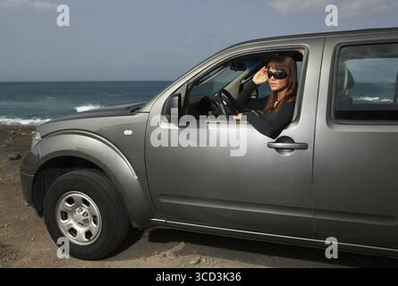 Woman and her 4wd car at the beach Stock Photo - Alamy