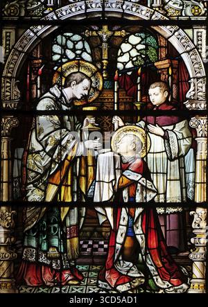 Stained glass window. The holy communion and the Virgin Mary ...