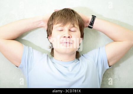 relaxed white man against of the rooms wall Stock Photo - Alamy