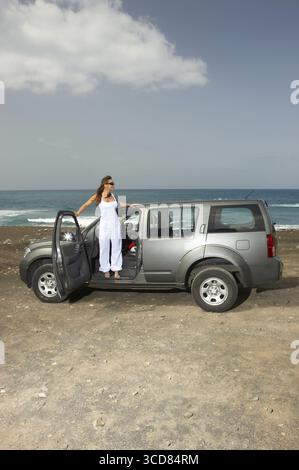 Woman and her 4wd car at the beach Stock Photo - Alamy