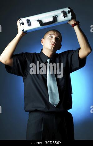A businessman holding case over his head Stock Photo - Alamy