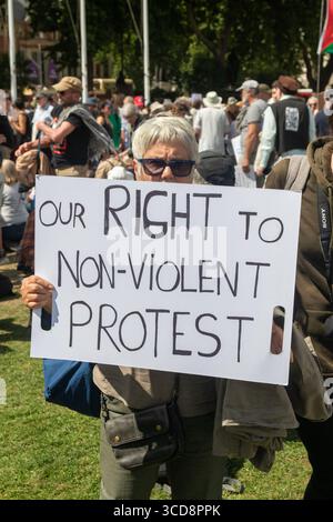 Protesters hold signs and banners at a Stop Adani Mine rally on the ...