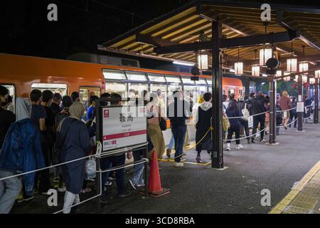 Crowds of passengers disembarking an Eiden 903 train arriving at Kurama ...