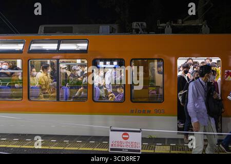 Passengers in crowded Eiden 903 train arriving at Kurama Station; Sakyo ...