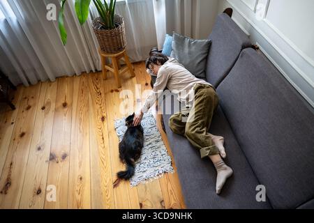 Mental health struggle, melancholic woman petting cat at home ...