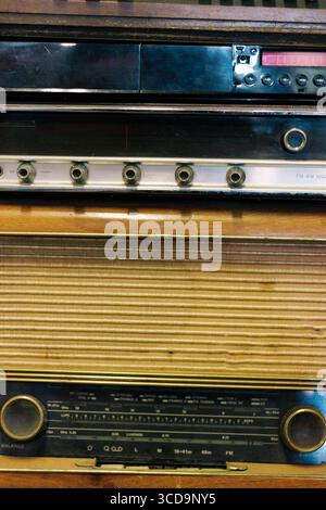 A view of very colorful antique broadcast radios from different eras ...