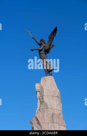 A bronze statue of an angel holding an Orthodox cross on the Russalka ...