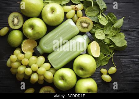 Different bottles of juice on wooden table Stock Photo - Alamy