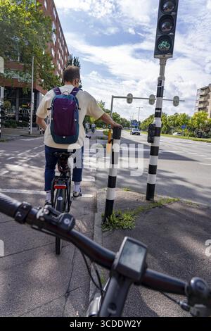 Bike lane separated from traffic with bollards and concrete kerb and ...