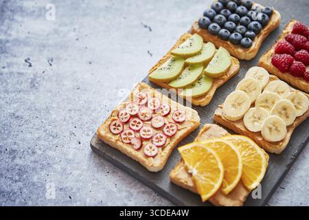 Six Healthy breakfast toasts. Wholegrain bread slices with peanut ...
