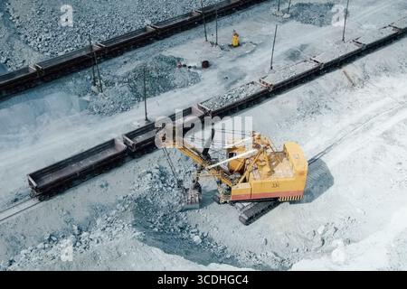 Loading of crushed stone into trolleys on the railway track Stock Photo ...