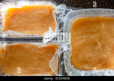 fruit purees are stored in plastic containers ready for further use ...