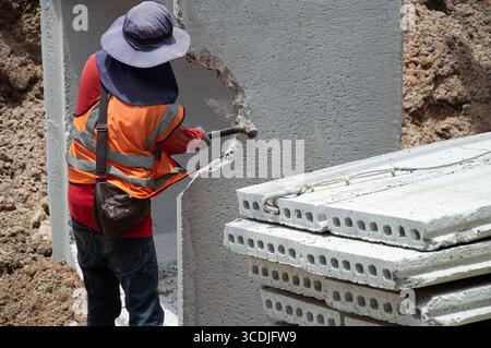 Workers are using hammers to break concrete blocks at a construction ...