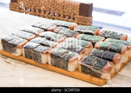 Individual wrapped Spam musubi on tray, Honolulu, Oahu, Hawaii, USA ...