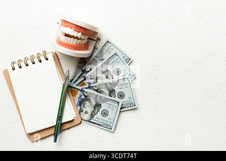 Flat lay composition with educational dental typodont model and money ...