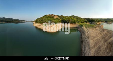 Aerial view of emerald waters embrace towering limestone karsts, a ...