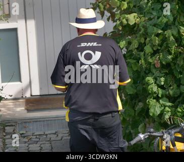 DHL Postbote bei der Auslieferung DHL - Postzusteller *** DHL letter ...