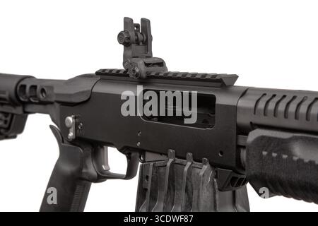 Close-up view of a tactical shotgun's receiver, sight, and magazine on ...