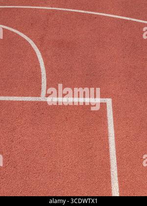 Outdoor basketball court lines and markings on concrete flooring ...