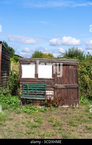 Crooked garden shed with seat Stock Photo - Alamy
