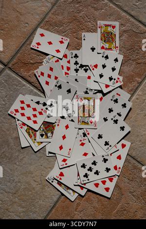 The playing cards scattered all over the floor, with the King card in ...