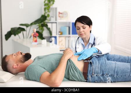 Gastroenterologist examining patient with stomach pain in clinic Stock ...