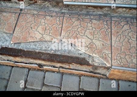 Broken tiled front porch stairs, damaged steps need repair. Poor ...