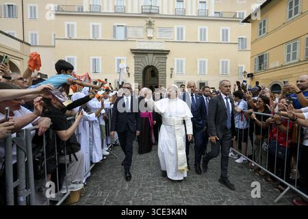 Pope Leo XIV is greeted by a faithful during the weekly general ...