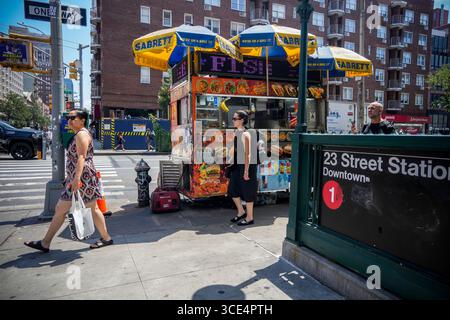 People walk their dogs in Chelsea in New York on Wednesday, June 16 ...