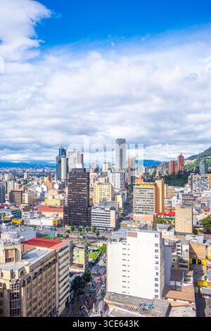 Modern city skyline with diverse skyscrapers behind lush green trees ...